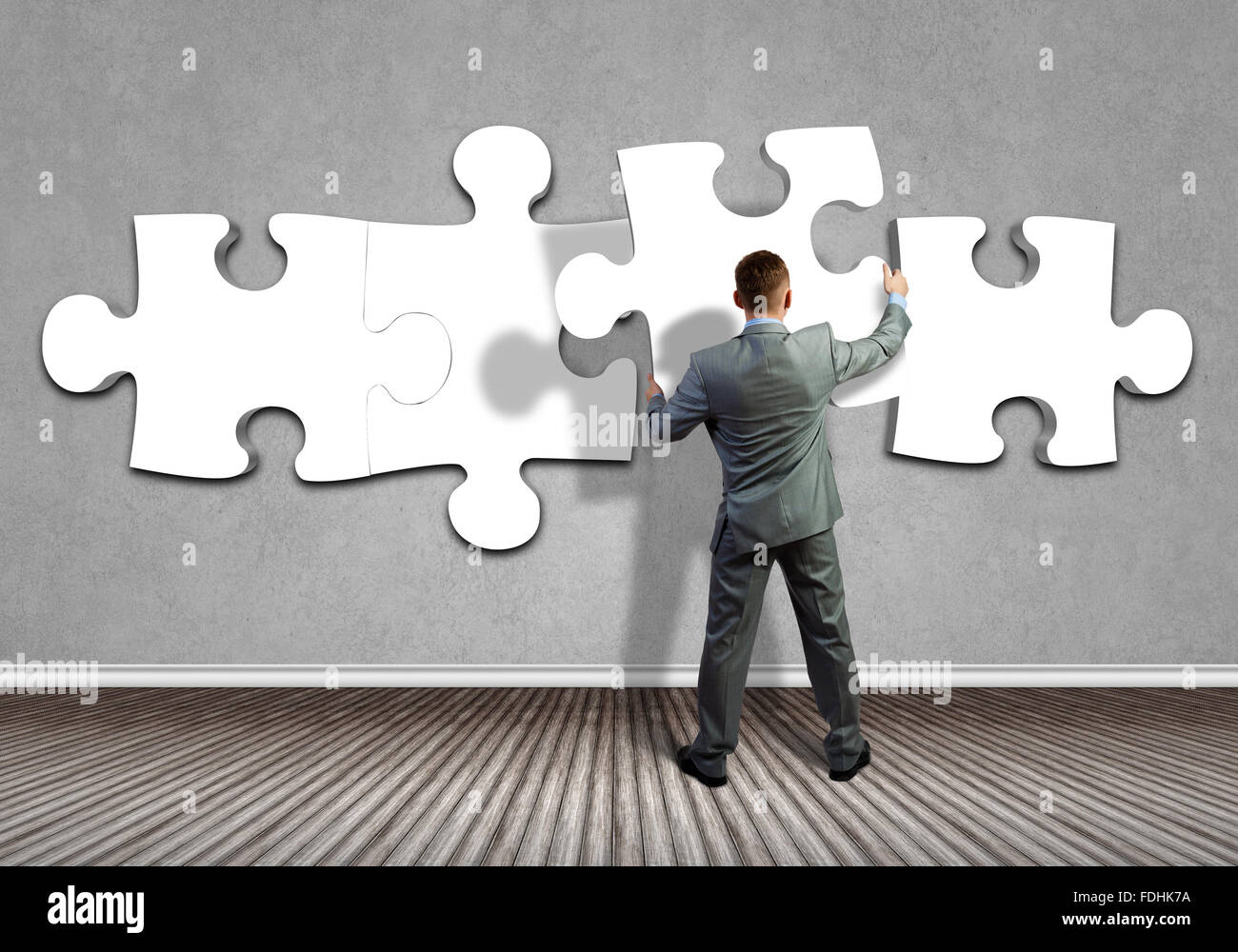 Rear view of businessman connecting white puzzle Stock Photo - Alamy