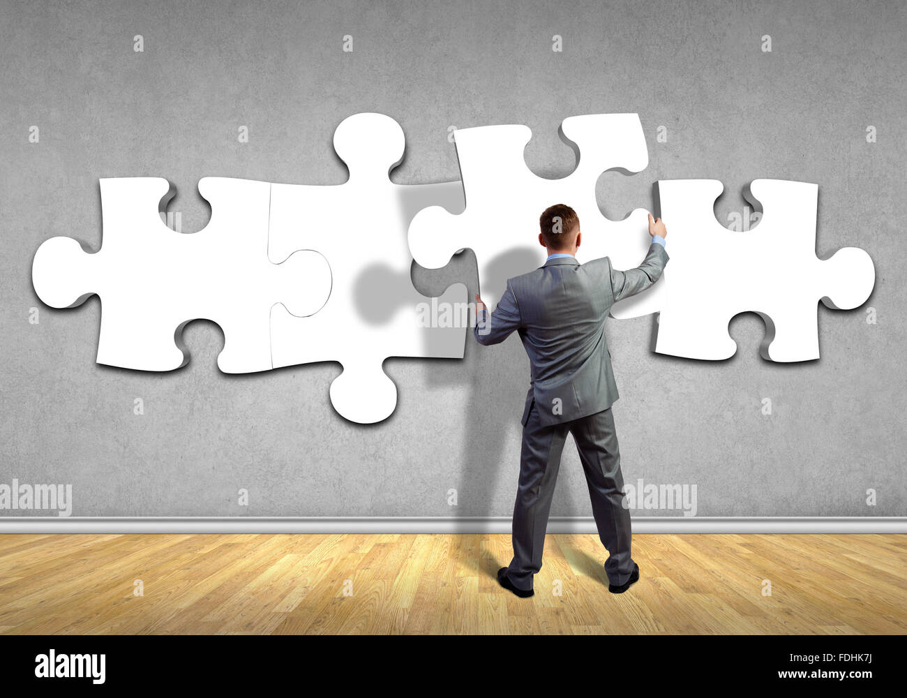Rear view of businessman connecting white puzzle Stock Photo - Alamy