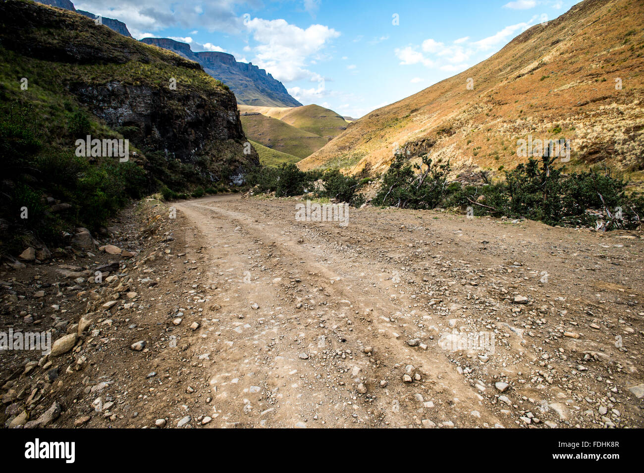 Empty dirt road winding through Sani Pass, between South Africa and ...
