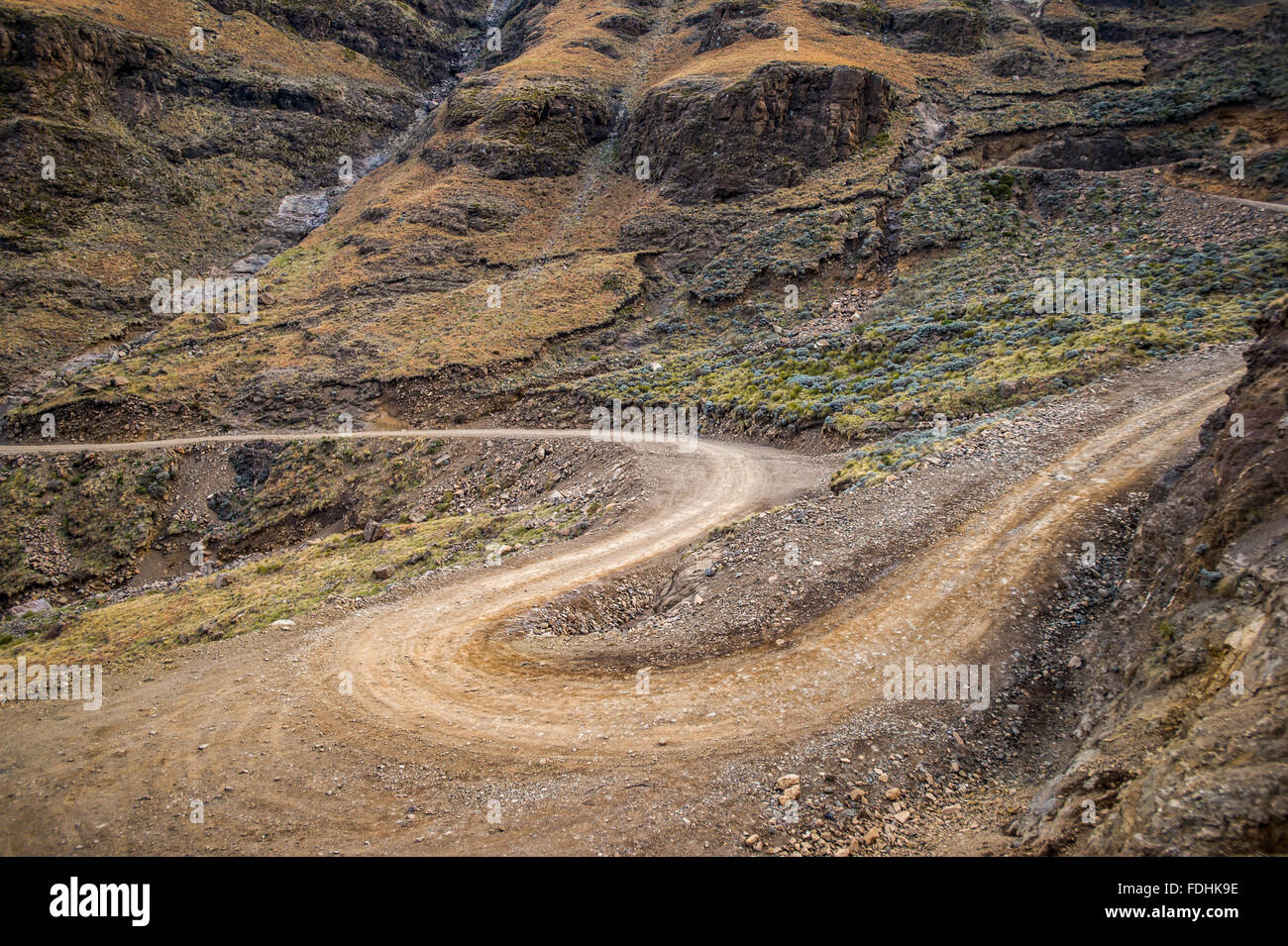 Empty dirt road winding through Sani Pass, between South Africa and ...