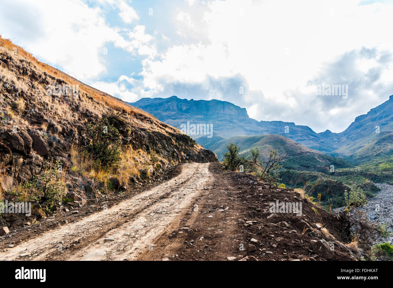 Empty dirt road winding through Sani Pass, between South Africa and ...