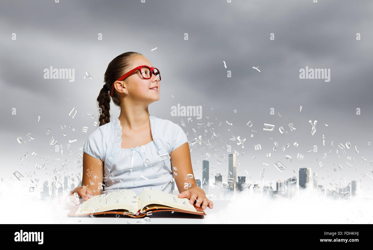 School pretty girl in red glasses reading book Stock Photo - Alamy
