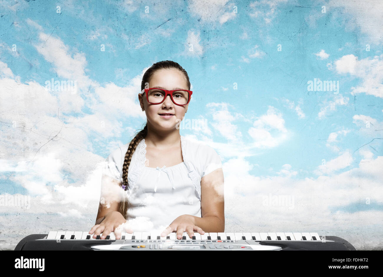 Pretty school girl in funny glasses playing piano Stock Photo - Alamy
