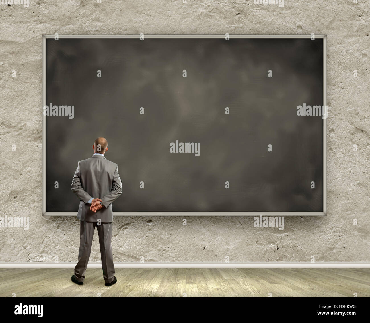 Rear view of businessman looking at chalkboard Stock Photo - Alamy