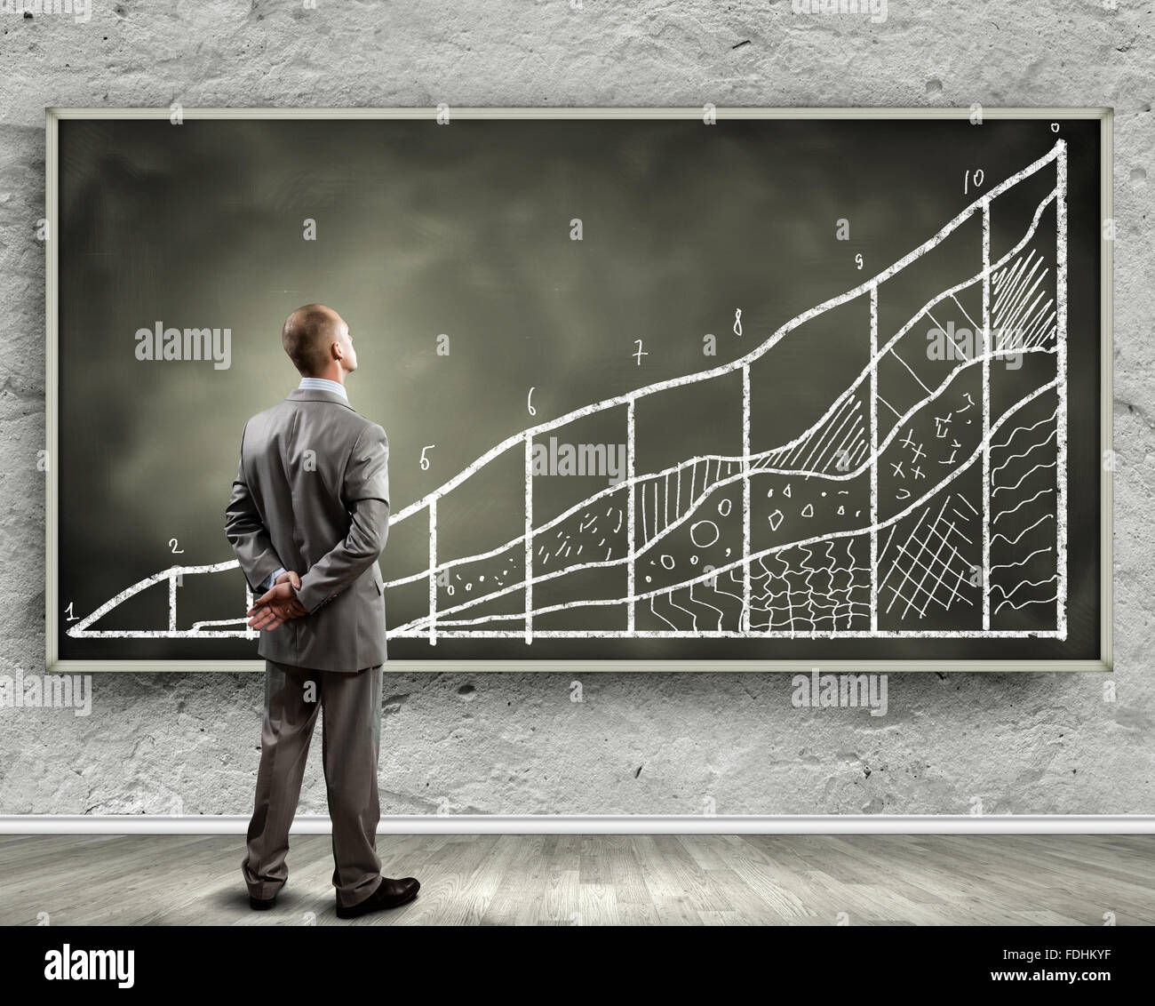 Rear view of businessman looking at chalkboard Stock Photo - Alamy