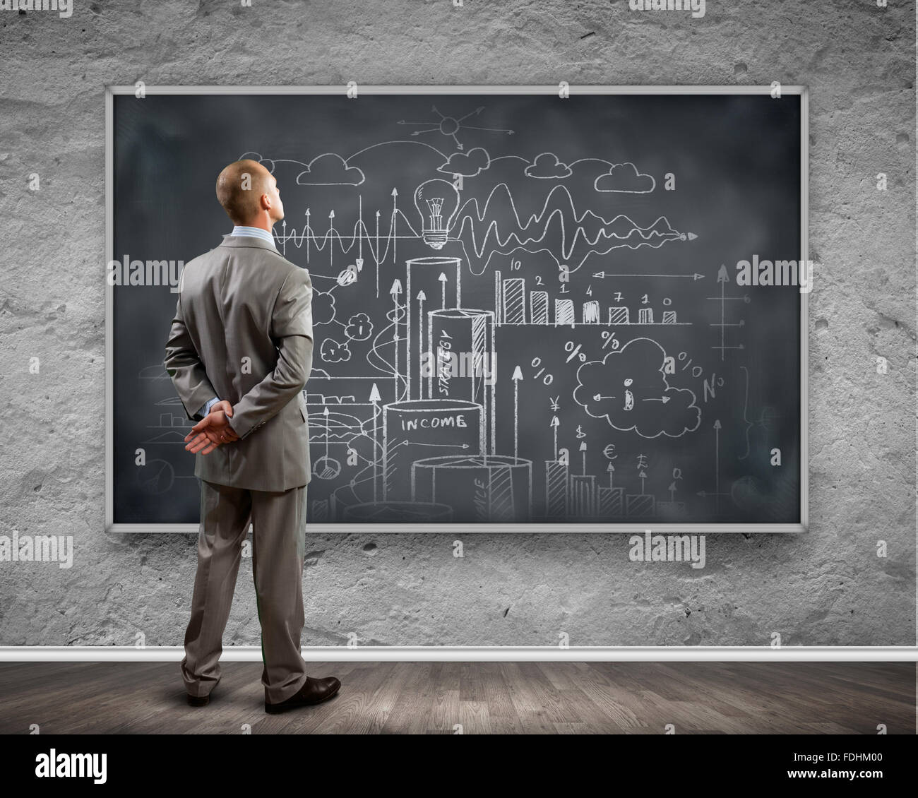 Rear view of businessman looking at chalkboard Stock Photo - Alamy