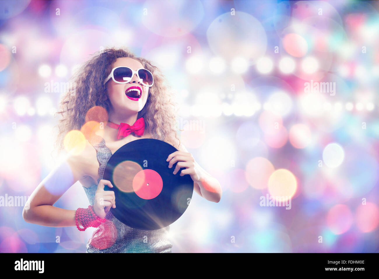 Young pretty girl dj at disco party holding vinyl Stock Photo - Alamy