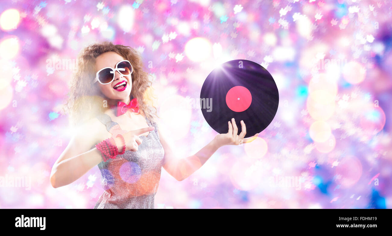 Young pretty girl dj at disco party holding vinyl Stock Photo - Alamy