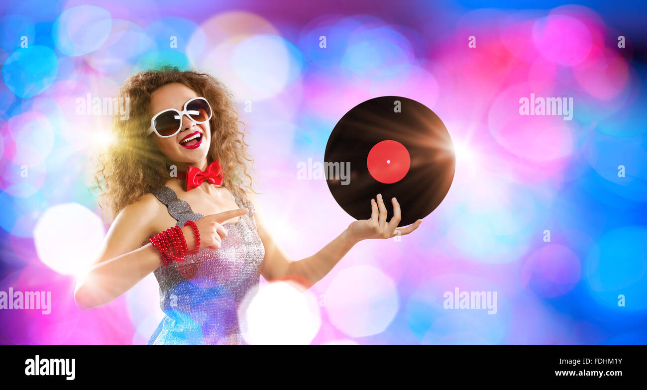 Young pretty girl dj at disco party holding vinyl Stock Photo - Alamy