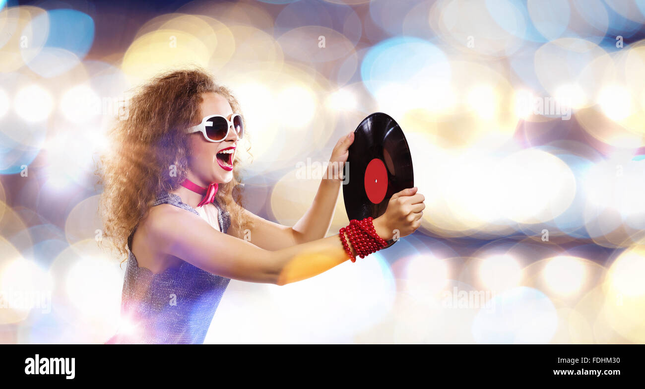 Young pretty girl dj at disco party holding vinyl Stock Photo - Alamy