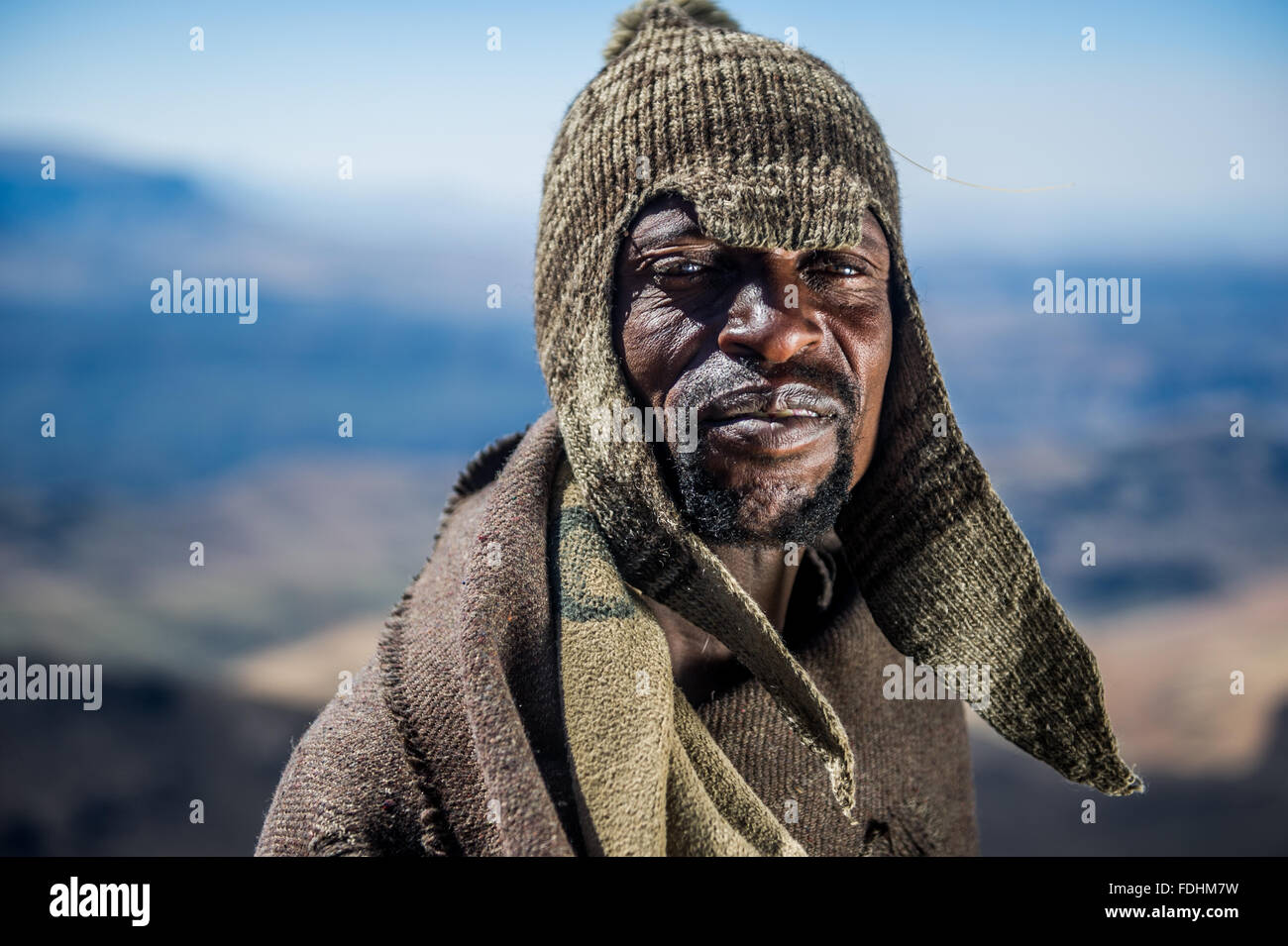 Portrait of a local shepherd wrapped in a blanket in the mountains of ...