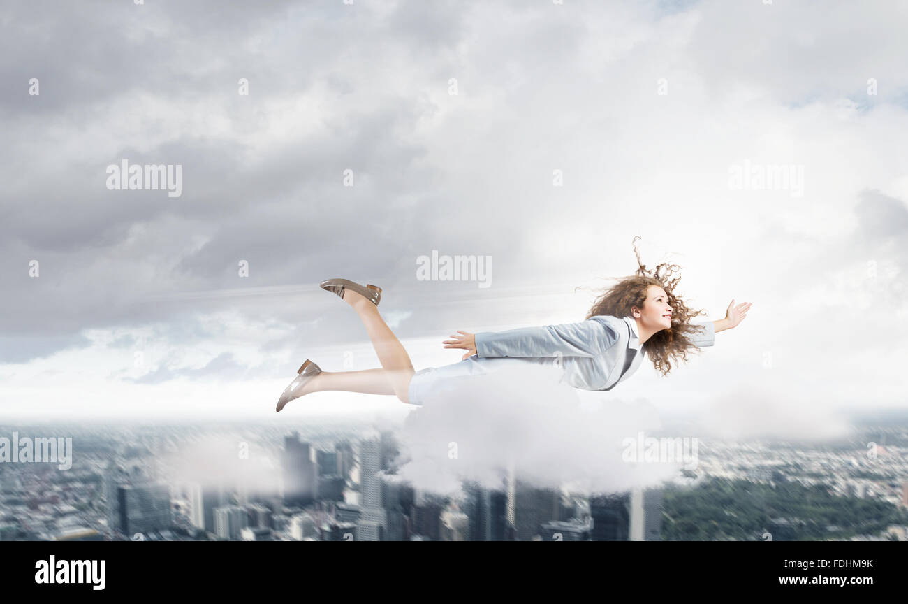 Young pretty businesswoman flying in sky above city Stock Photo - Alamy