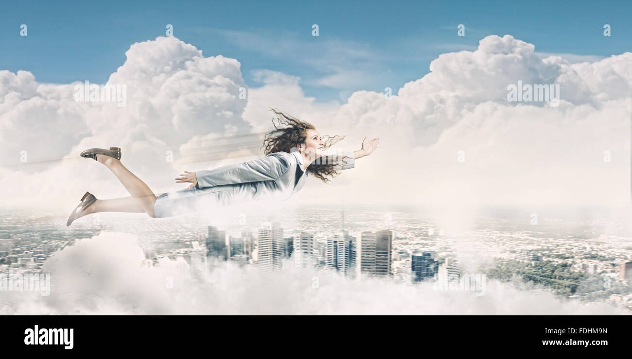 Young pretty businesswoman flying in sky above city Stock Photo - Alamy