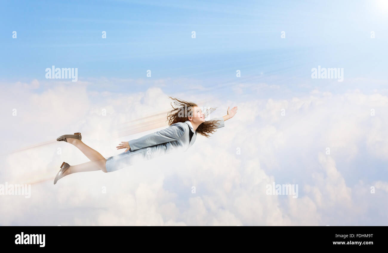 Young pretty businesswoman flying in blue sky Stock Photo - Alamy
