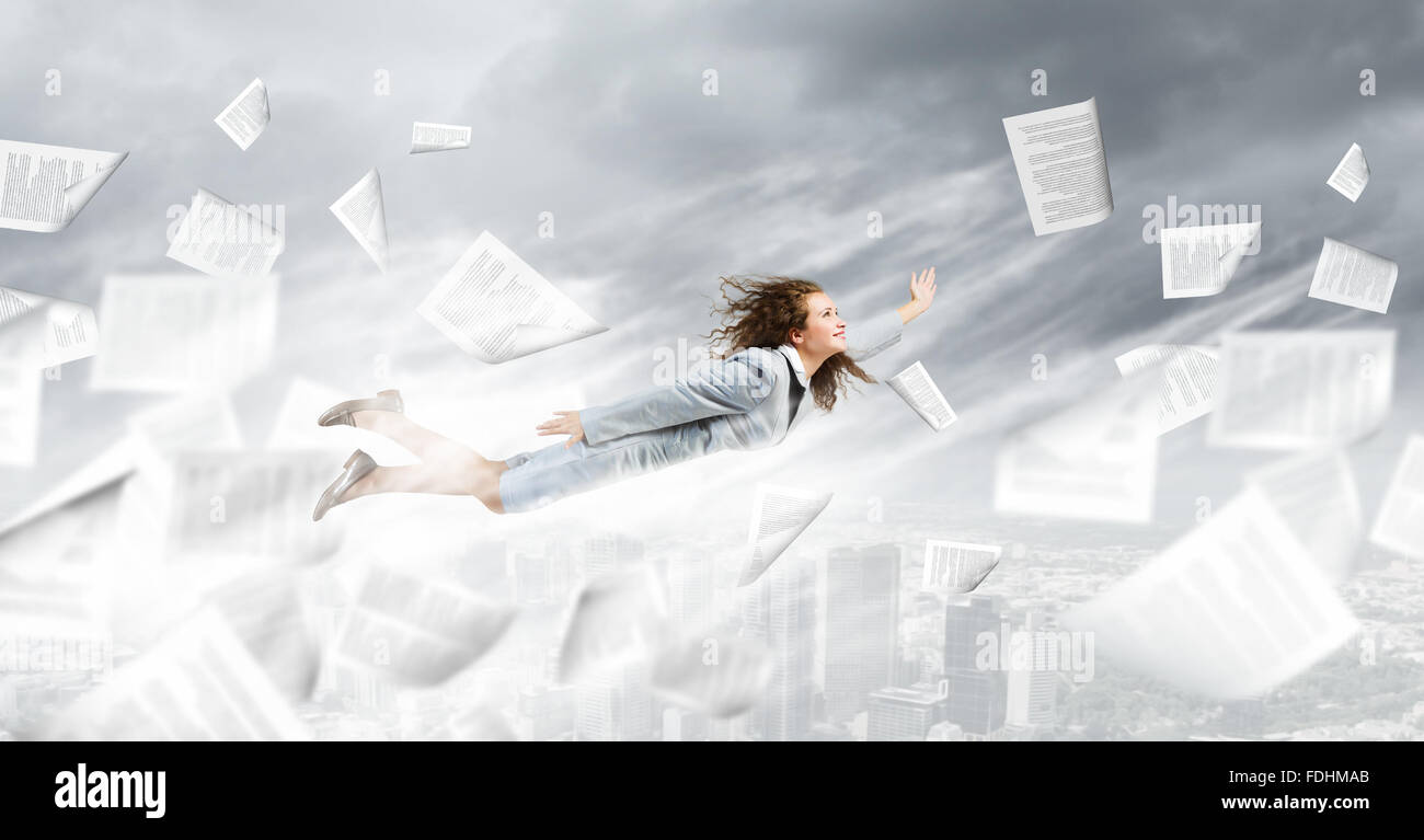 Young pretty businesswoman flying in sky above city Stock Photo - Alamy