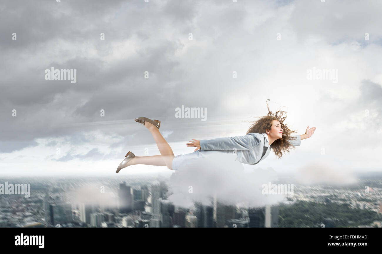 Young pretty businesswoman flying in sky above city Stock Photo - Alamy