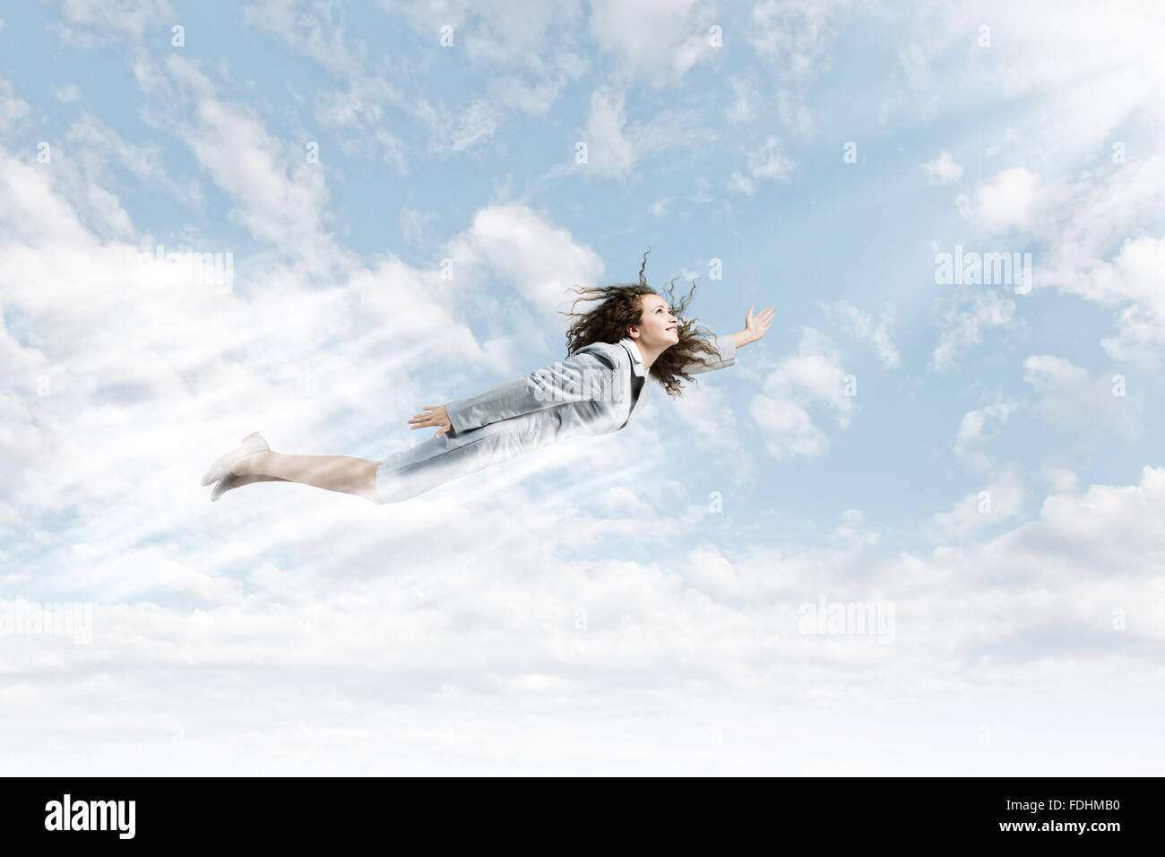 Young pretty businesswoman flying in blue sky Stock Photo - Alamy