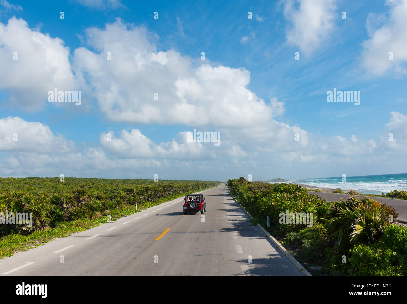 Open Top Red Jeep On Empty Seaside Road, Cozumel, Mexico Stock Photo ...