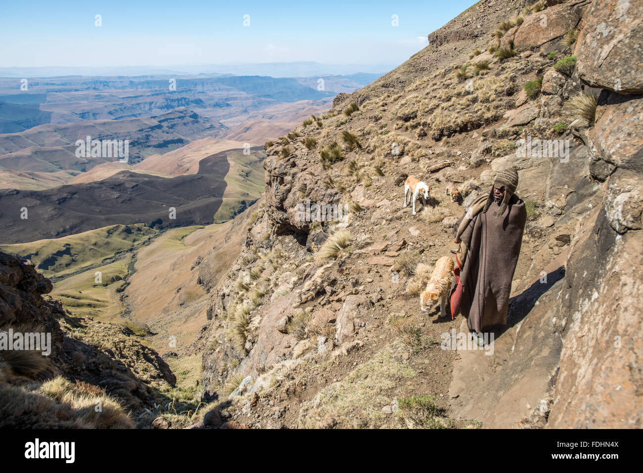 Portrait of a local shepherd with his dogs wrapped in a blanket in the ...