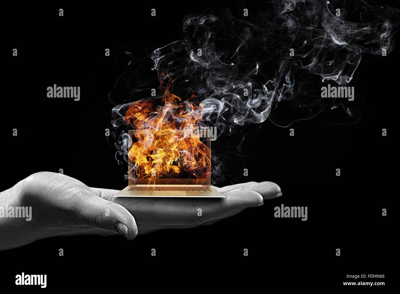 Human hand holding burning laptop on palm Stock Photo - Alamy