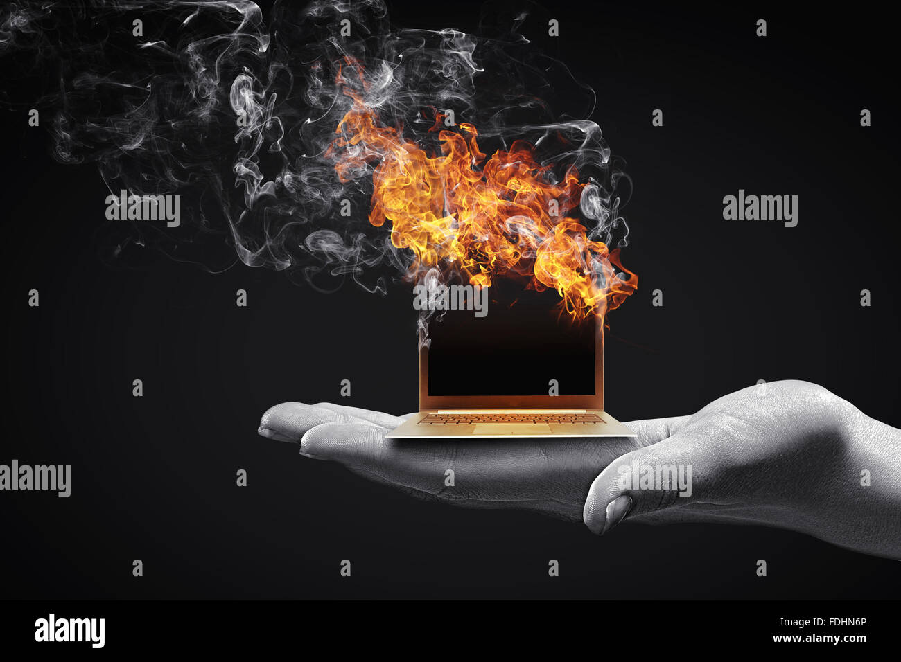 Human hand holding burning laptop on palm Stock Photo - Alamy
