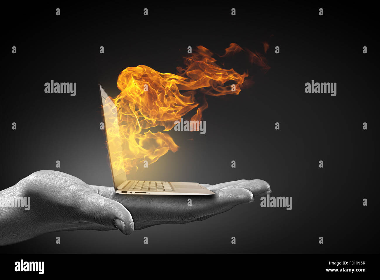 Human hand holding burning laptop on palm Stock Photo - Alamy