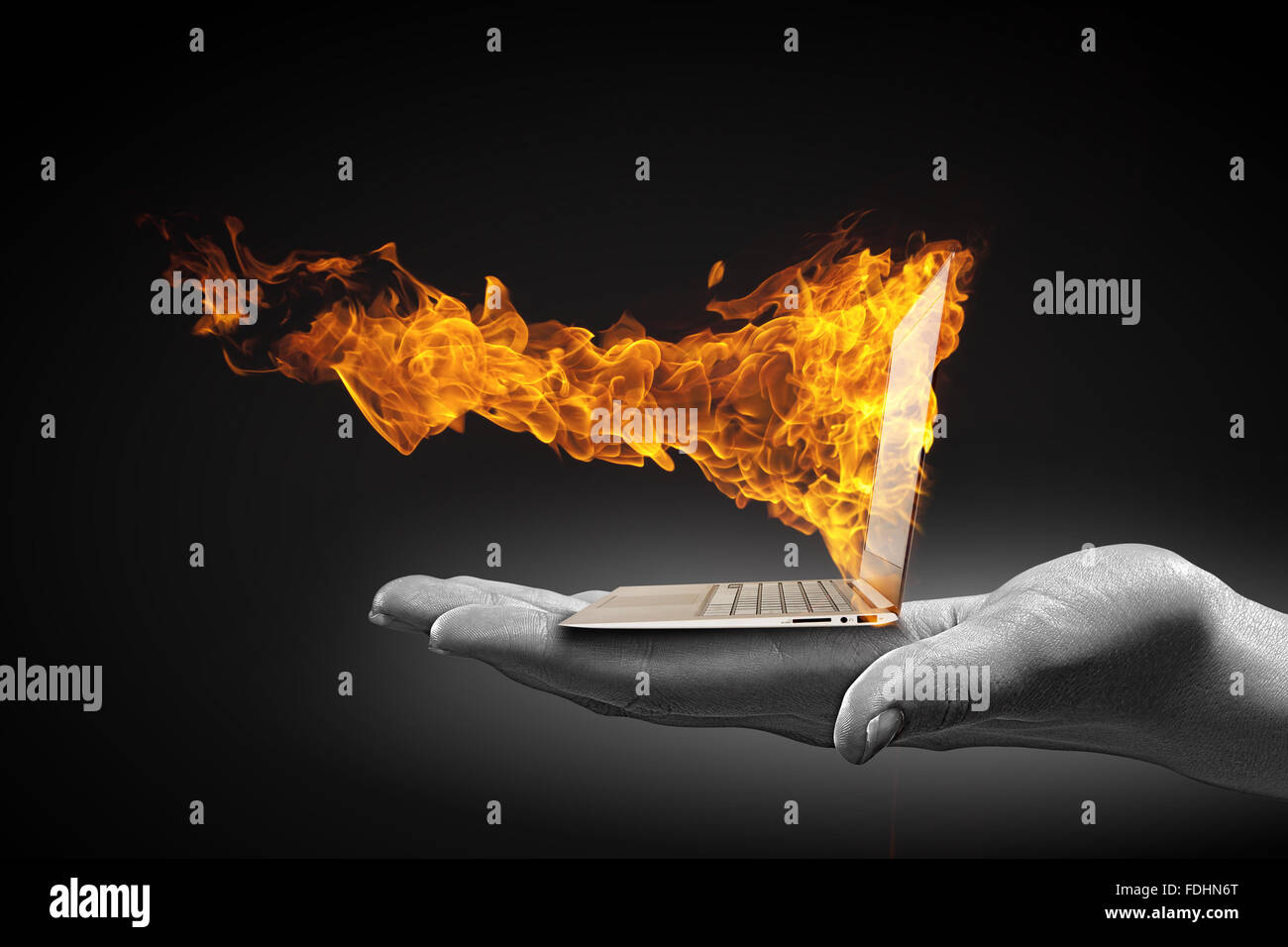Human hand holding burning laptop on palm Stock Photo - Alamy