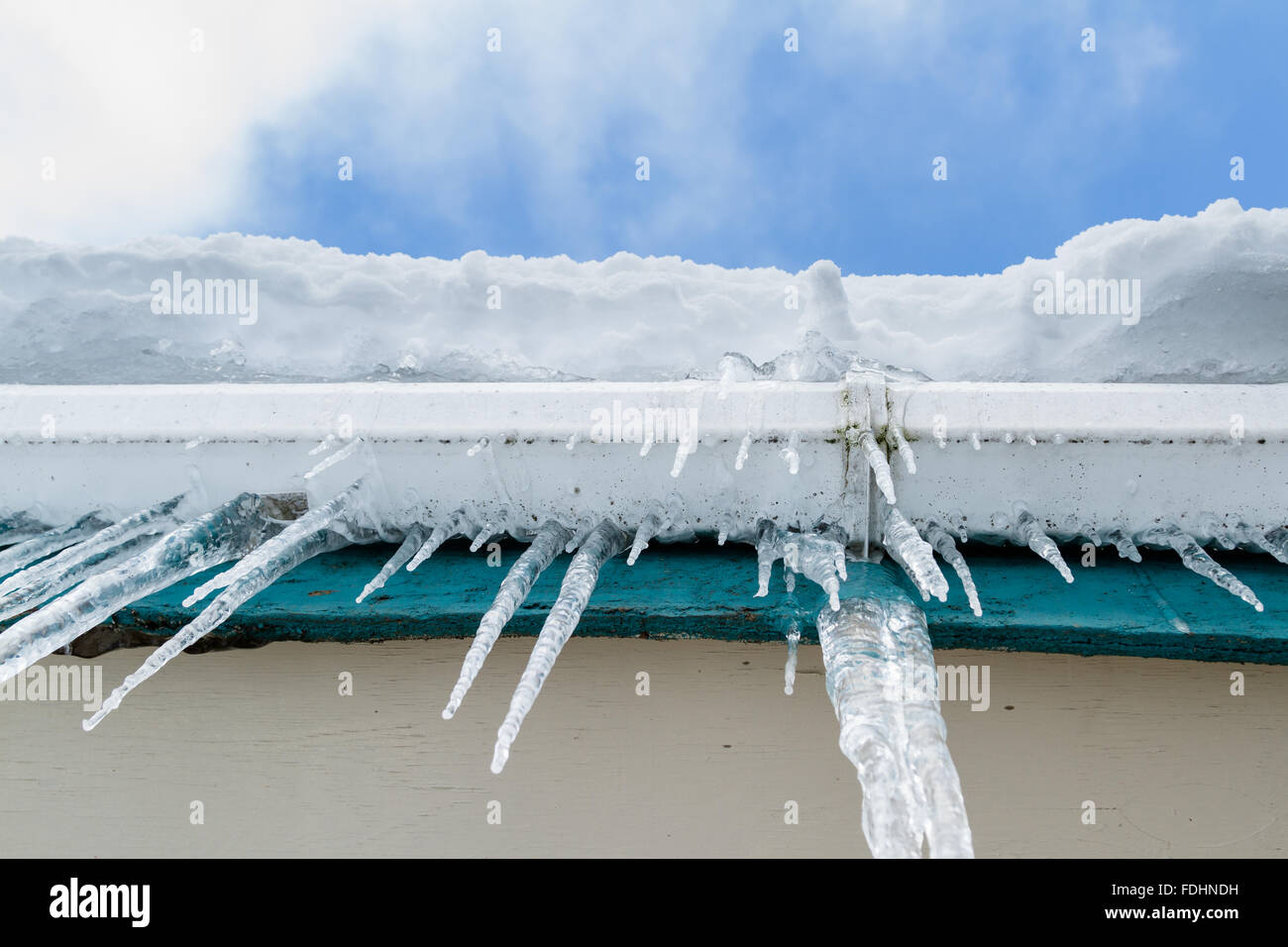 Icicles in all different shapes and sizes hanging down from the gutters ...