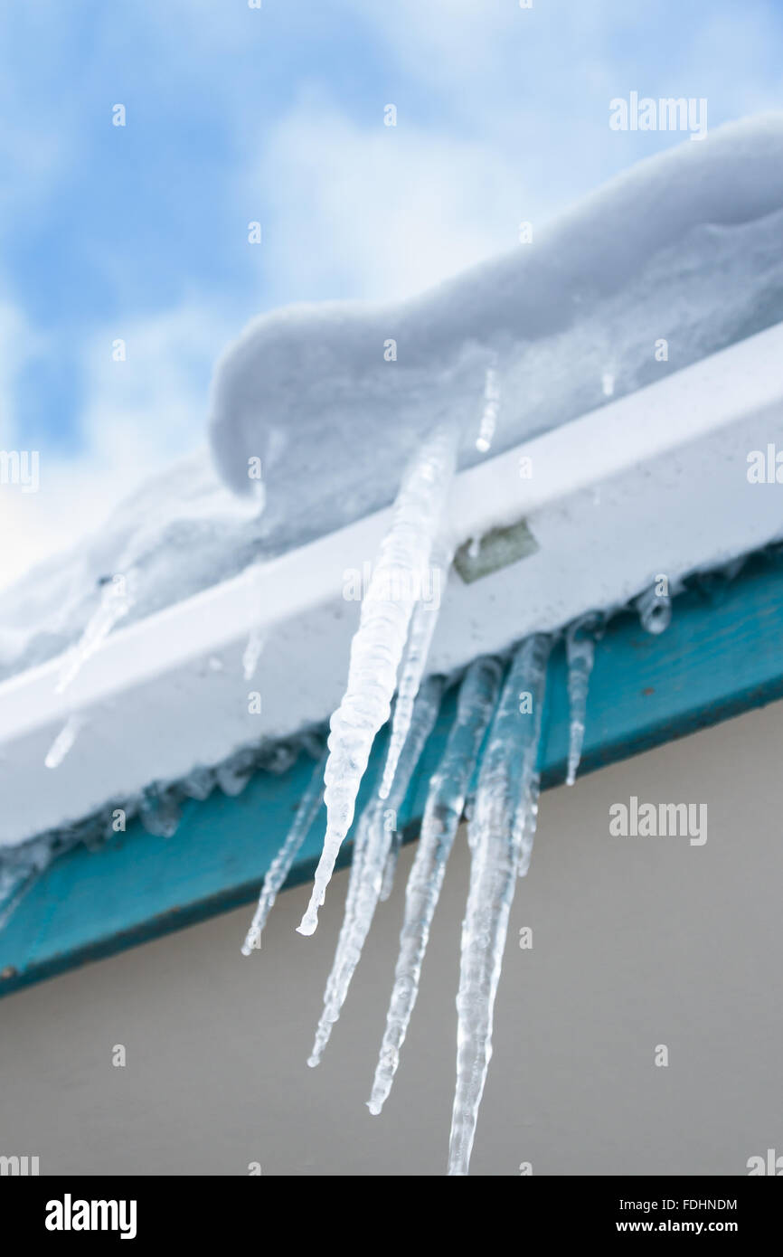 Icicles in all different shapes and sizes hanging down from the gutters ...