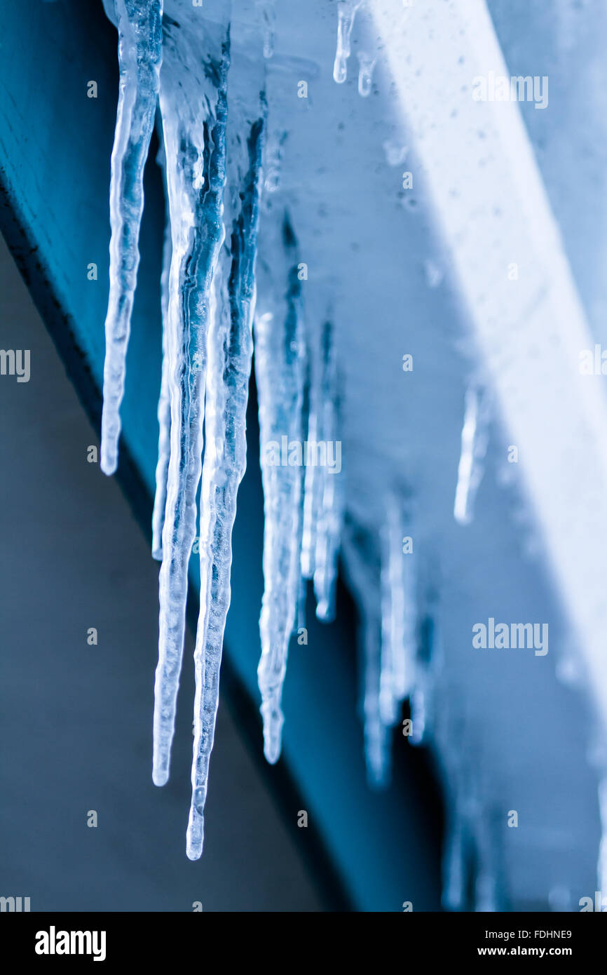 Icicles in all different shapes and sizes hanging down from the gutters ...