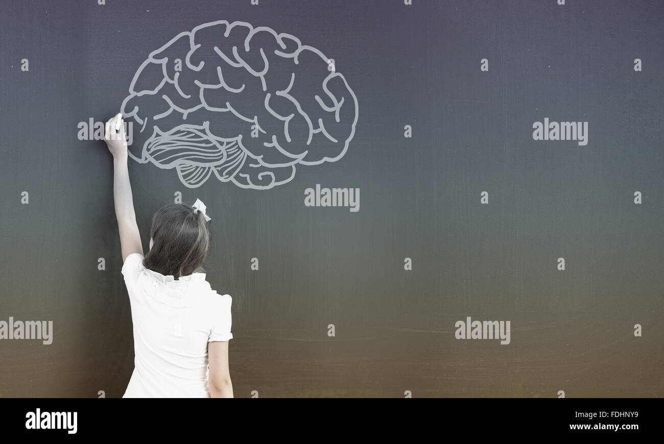 Cute little girl standing with back and drawing on blackboard Stock ...