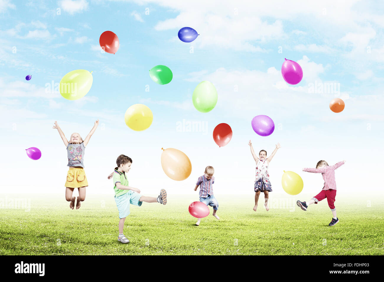 Group of happy children playing with colorful balloons Stock Photo - Alamy