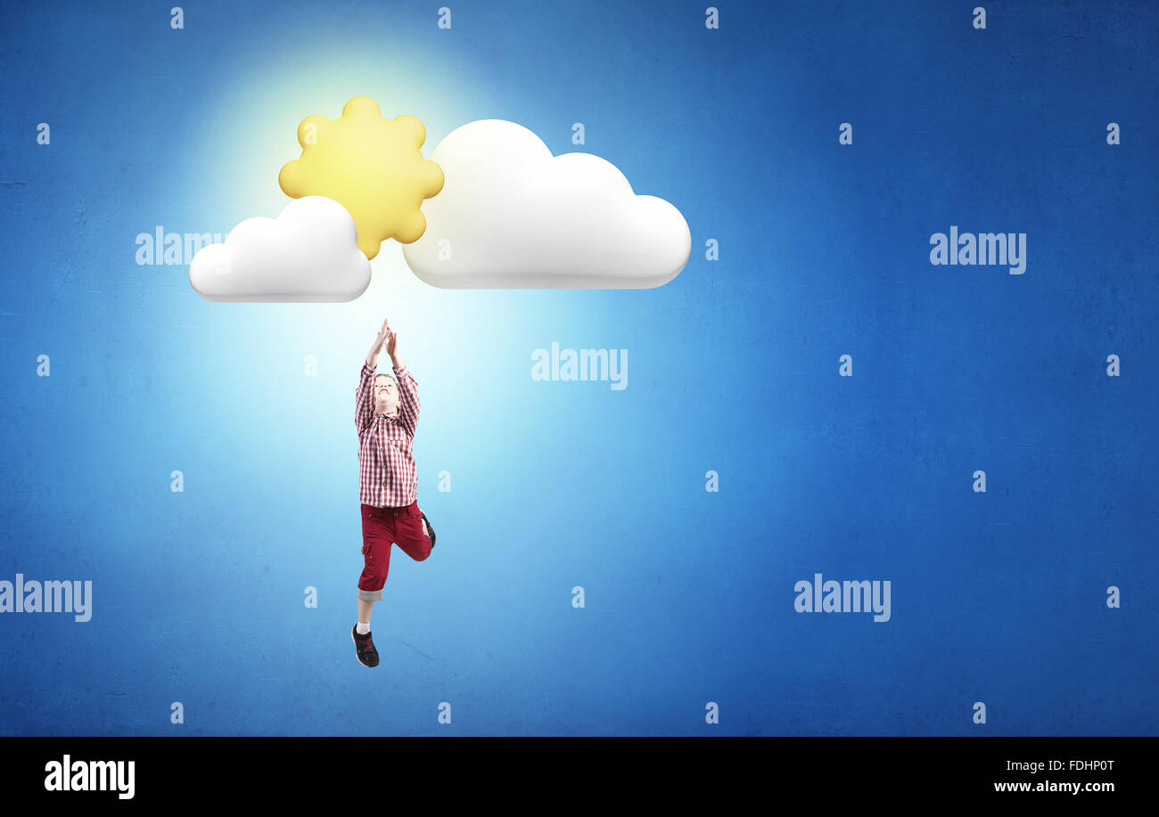 Little happy cute boy catching sun in sky Stock Photo - Alamy