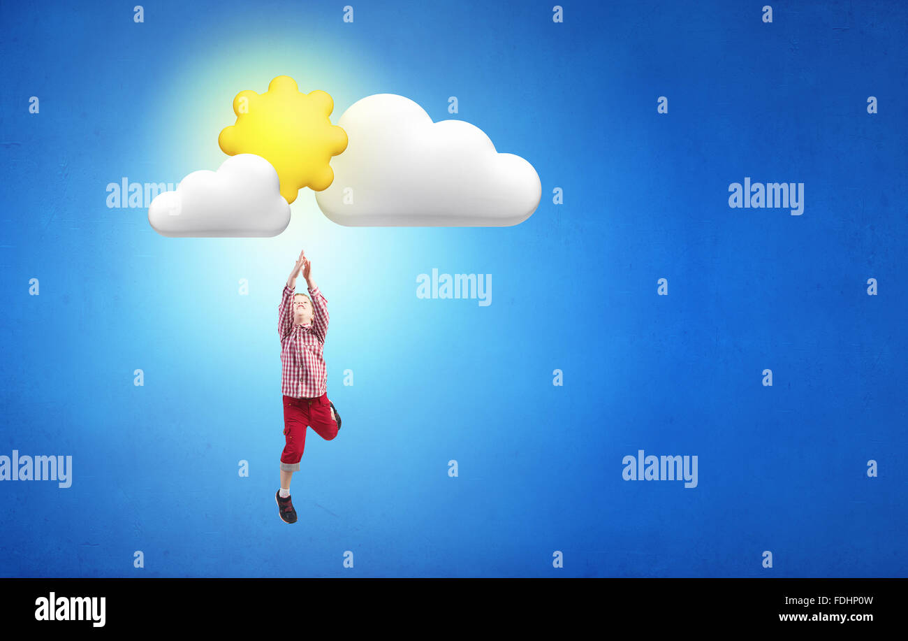 Little happy cute boy catching sun in sky Stock Photo - Alamy