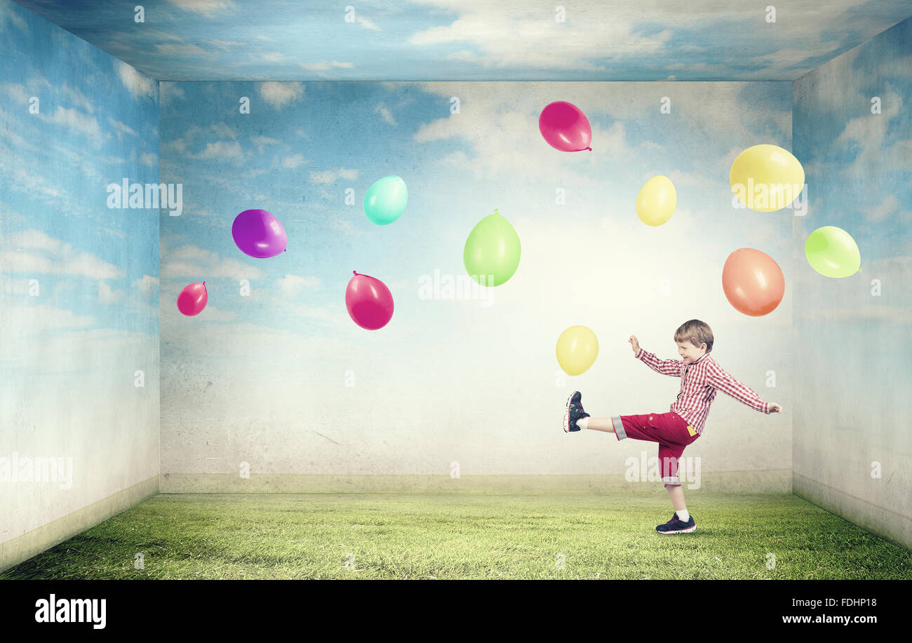 Little cute boy playing joyfully with colorful balloon Stock Photo - Alamy