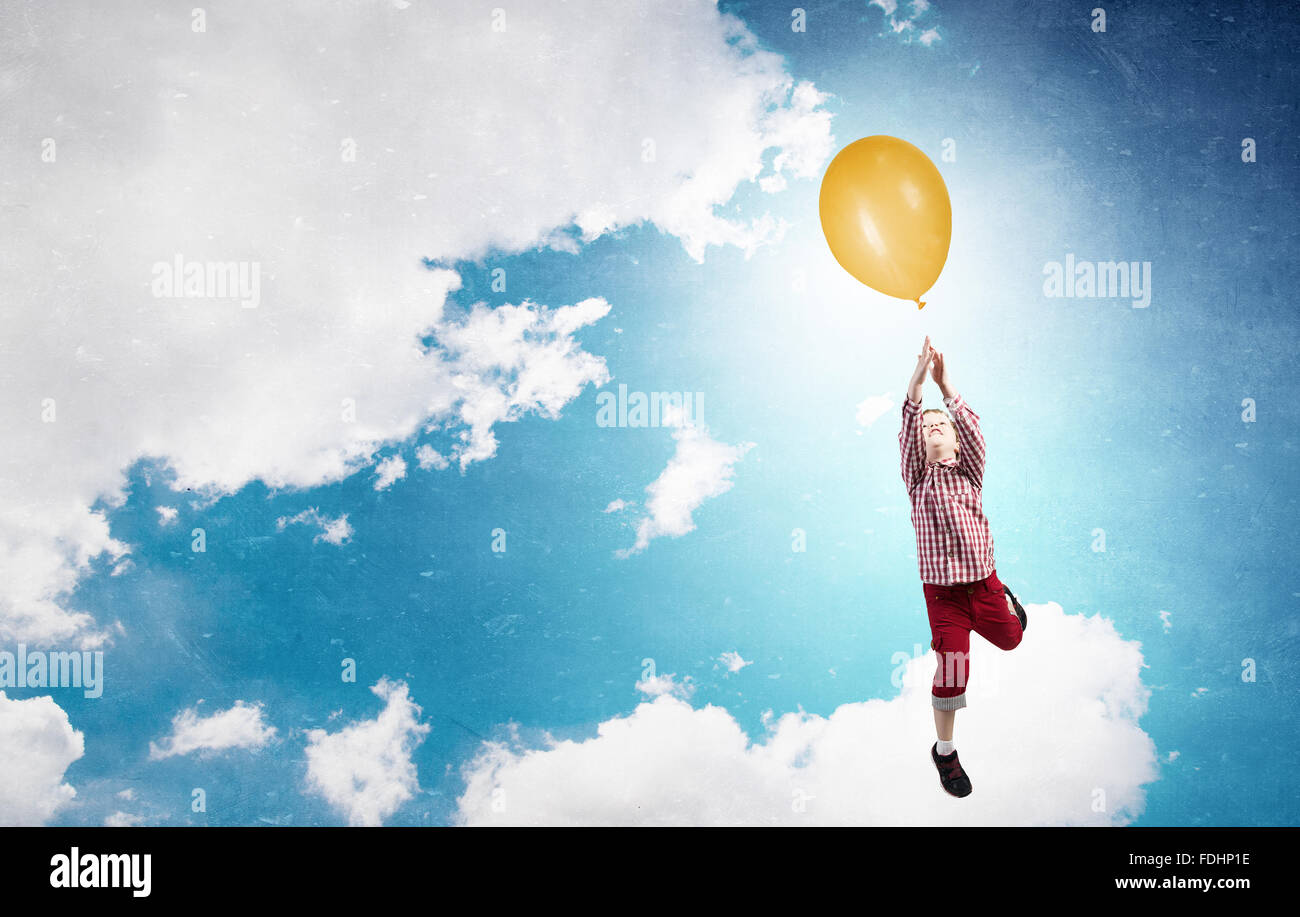 Little happy cute boy flying on balloon Stock Photo - Alamy