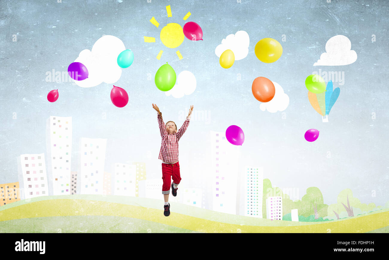 Little cute boy playing joyfully with colorful balloon Stock Photo - Alamy
