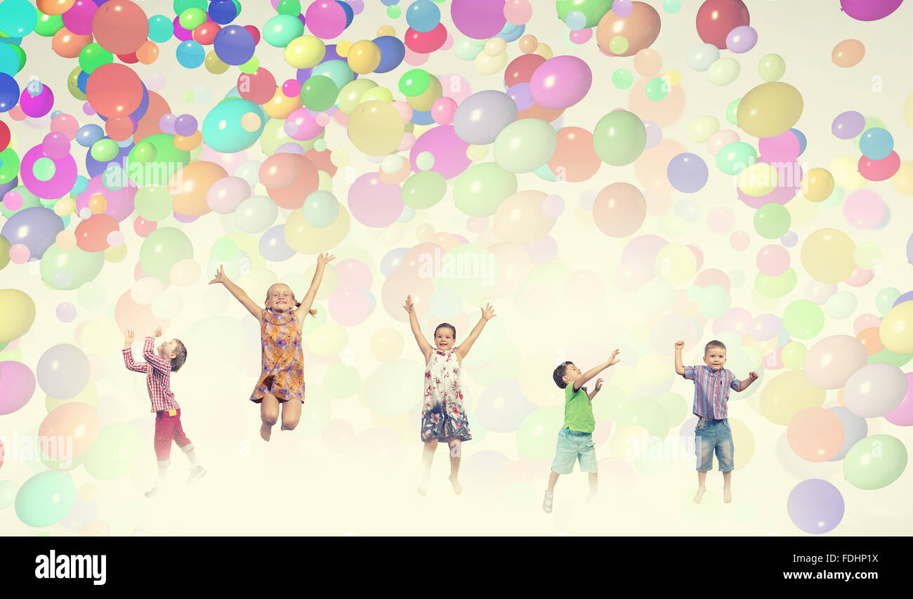 Group of happy children playing with colorful balloons Stock Photo - Alamy