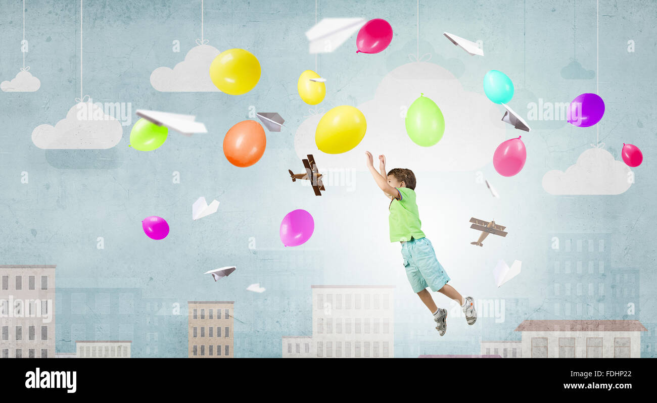 Little happy cute boy flying on balloon Stock Photo - Alamy