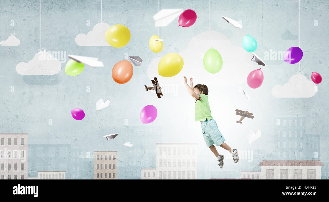 Little happy cute boy flying on balloon Stock Photo - Alamy
