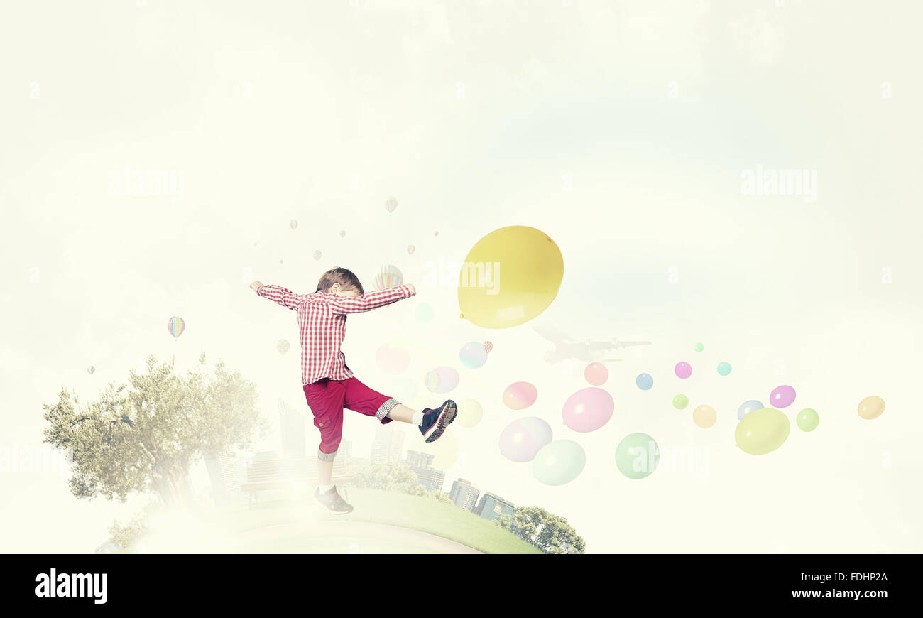 Little cute boy playing joyfully with colorful balloon Stock Photo - Alamy
