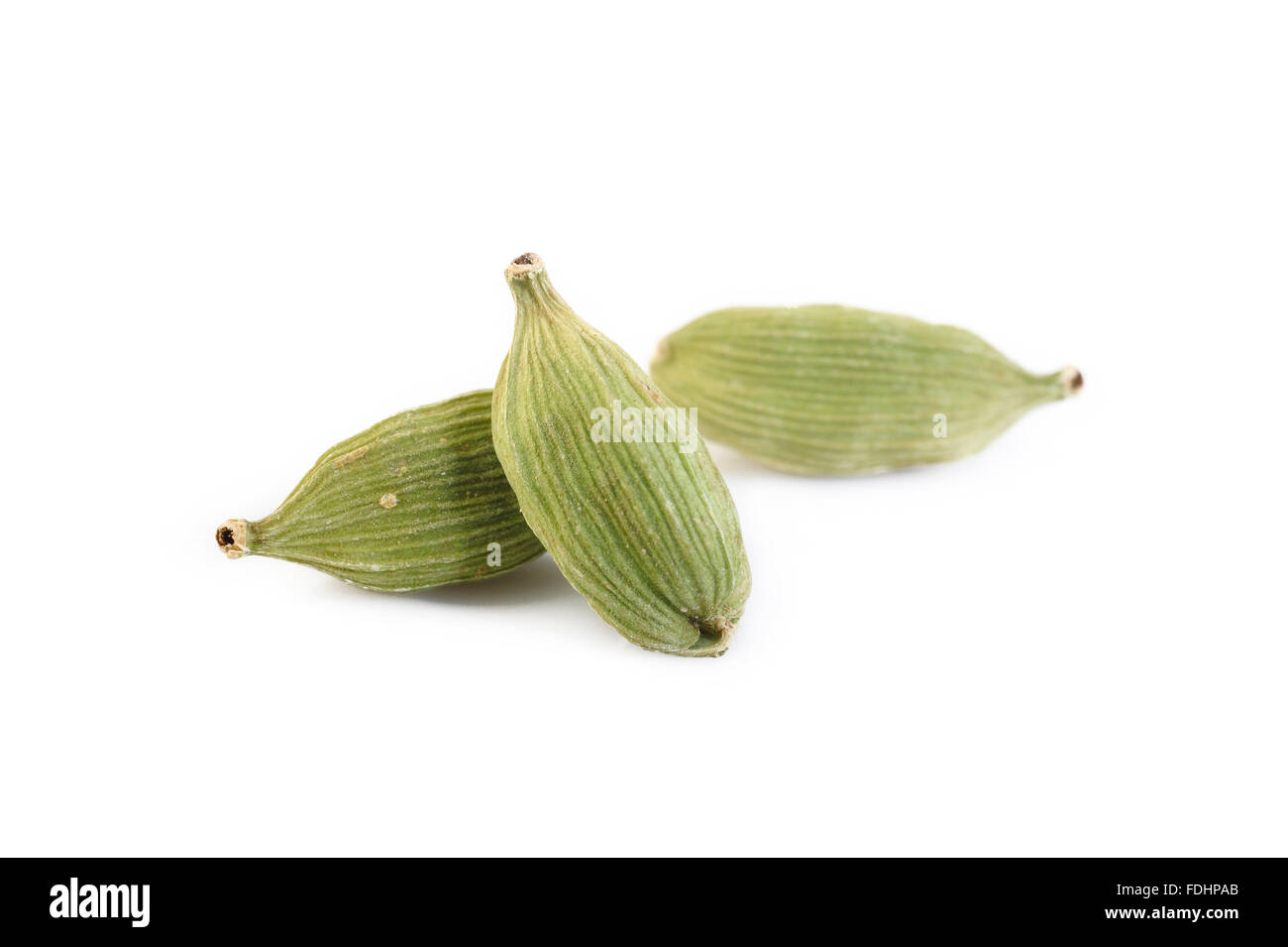 green cardamom pods isolated on white background Stock Photo - Alamy