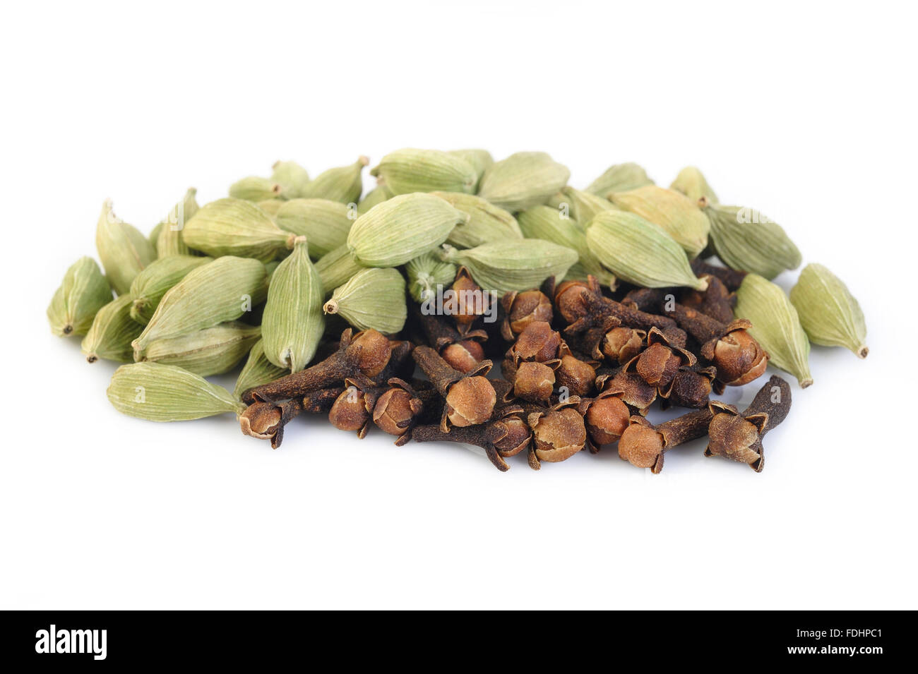 green cardamom pods and cloves on white background Stock Photo - Alamy