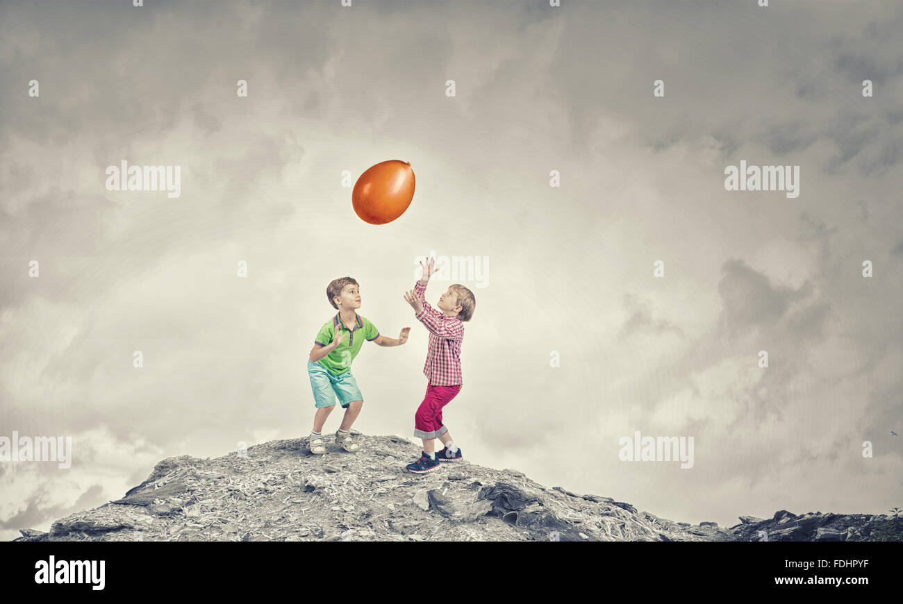 Little cute boys playing joyfully with colorful balloon Stock Photo - Alamy