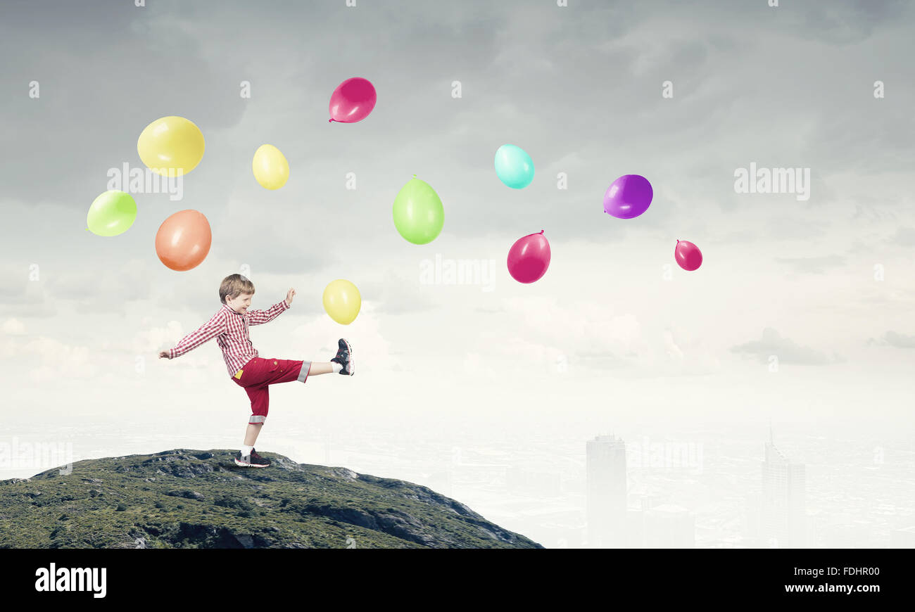 Little cute boy playing joyfully with colorful balloon Stock Photo - Alamy