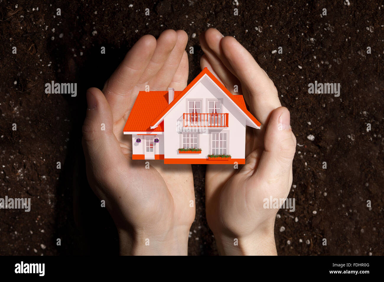 Hands holding house representing home ownership and real estate concept ...