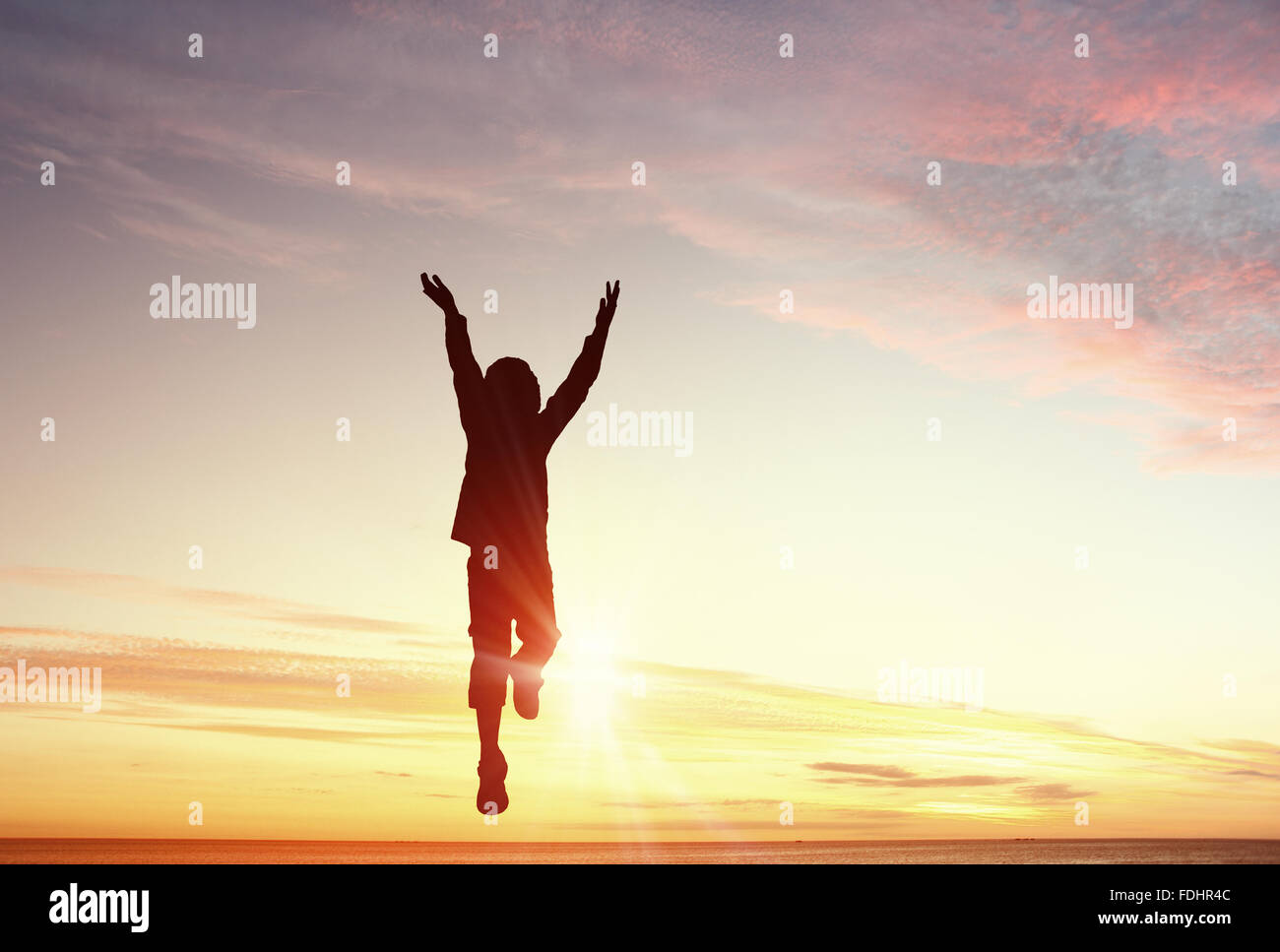 Silhouette of jumping kid boy over sunset background Stock Photo - Alamy