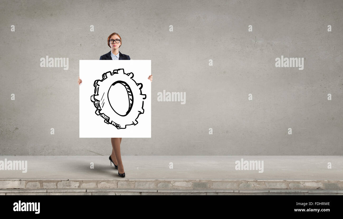 Businesswoman holding placard with cogwheel as teamwork symbol Stock ...