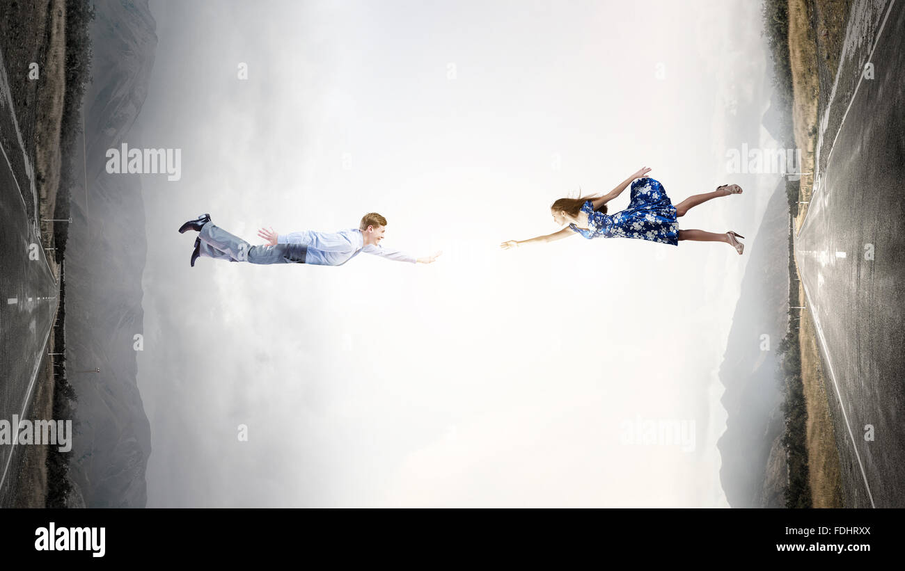 Young woman in dress and man on road between two realities Stock Photo ...