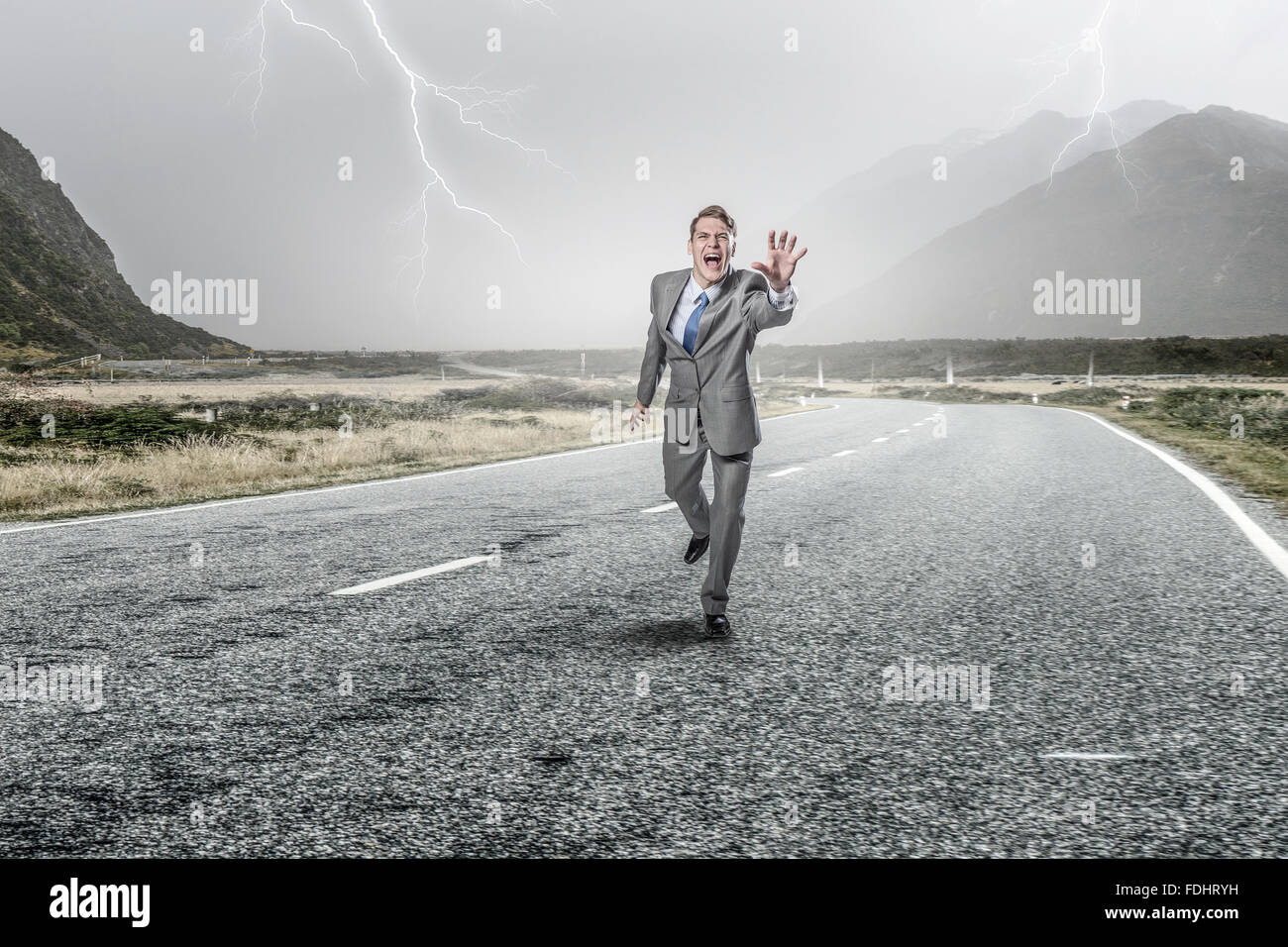Young screaming businessman running on asphalt road Stock Photo - Alamy